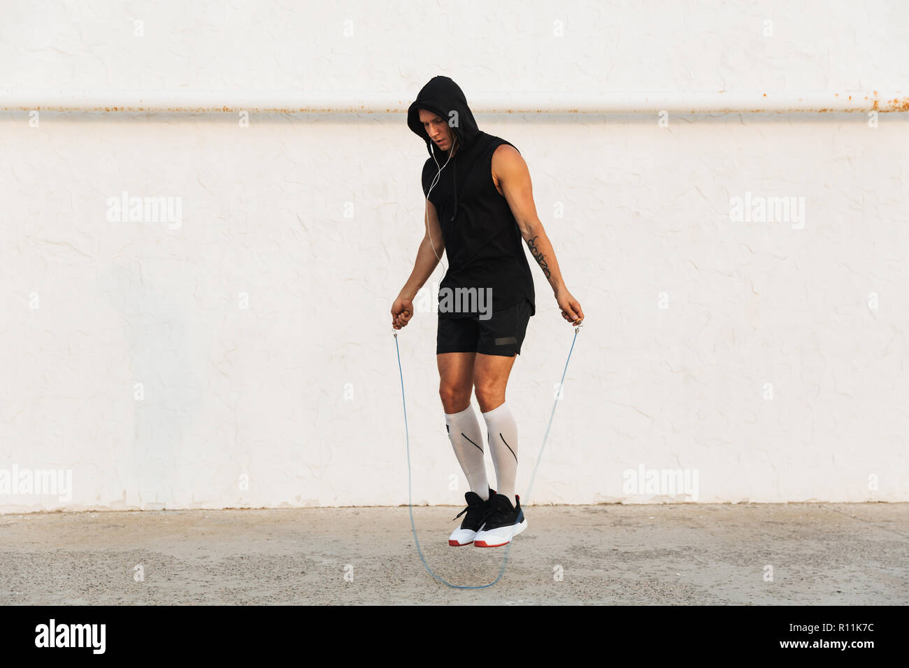 Picture of strong young sportsman outdoors at the beach make sport ...