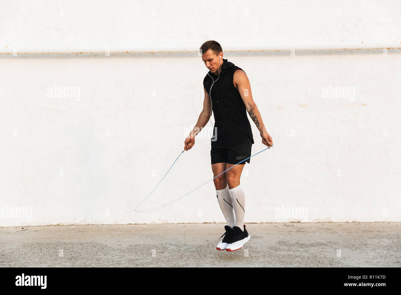 Picture of strong young sportsman outdoors at the beach make sport ...