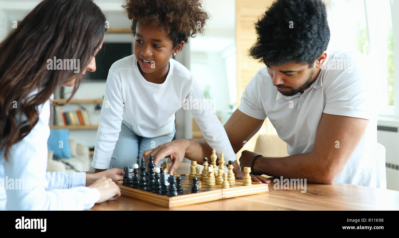 Happy family playing chess together at home Stock Photo - Alamy