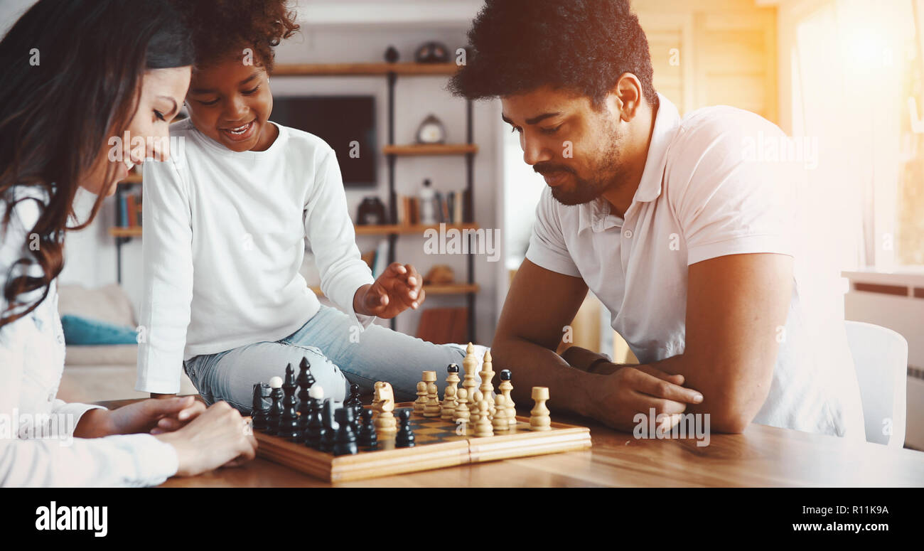 Happy family playing chess together at home Stock Photo - Alamy