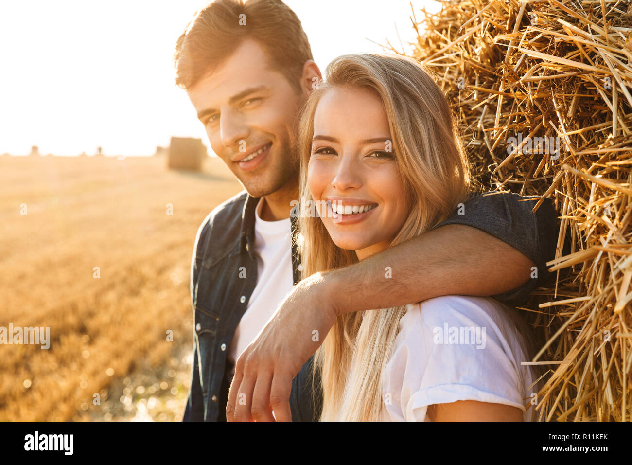 Image of attractive people man and woman walking on golden field and ...