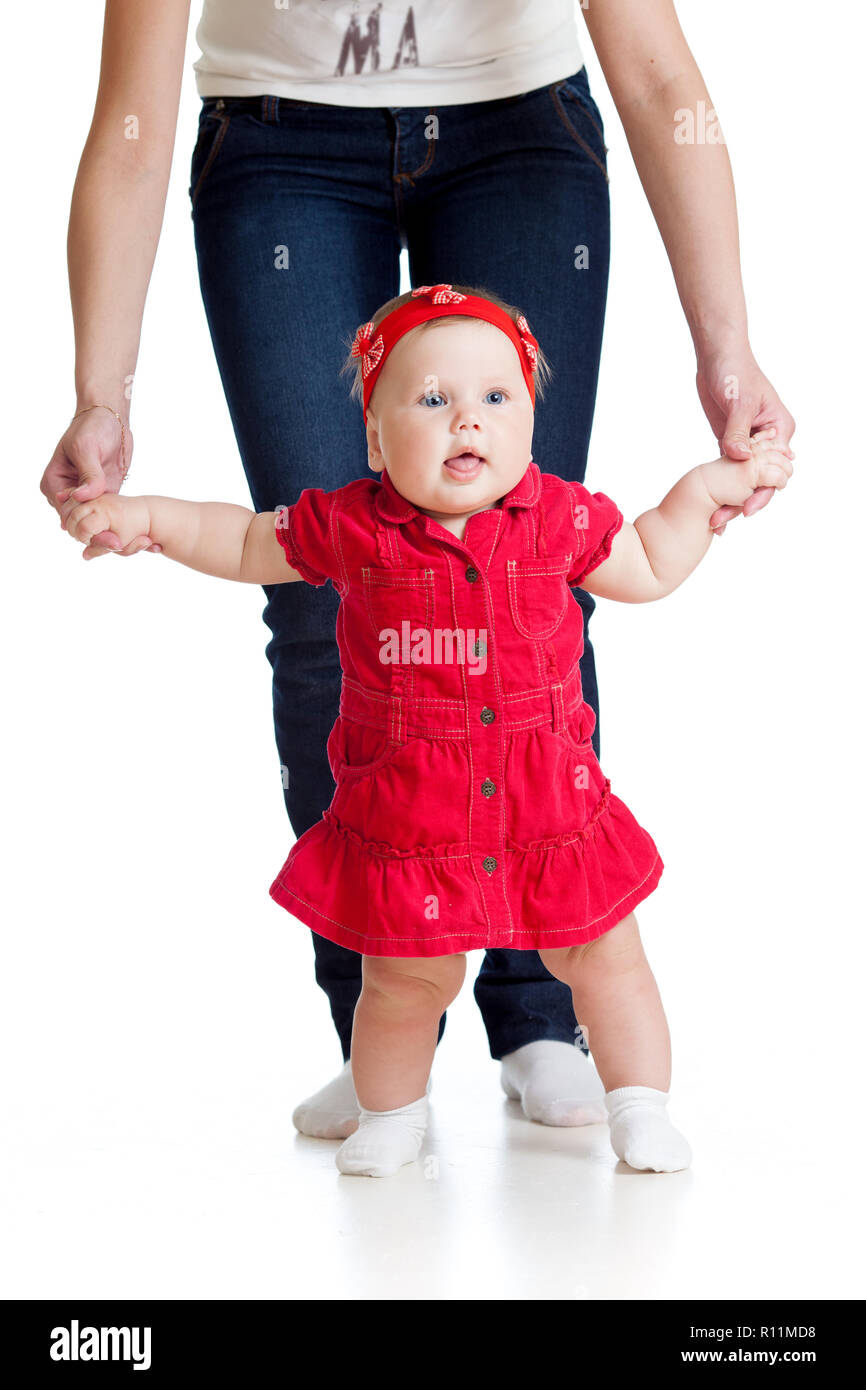 Mom with her 8 months old baby, making first steps together. Isolated ...