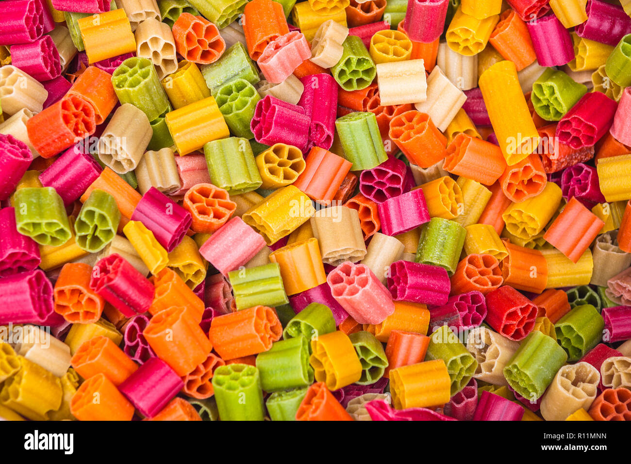 Food background - uncooked colored wheat pasta Stock Photo - Alamy