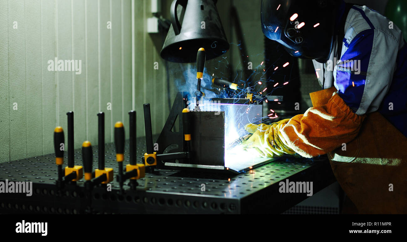 Metal worker welding in metal industry factory Stock Photo - Alamy