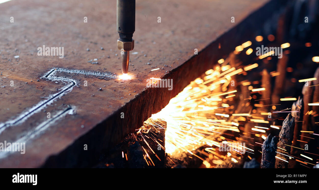 Oxygen torch cuts steel sheet. CNC gas cutting machine. Bright sparks ...
