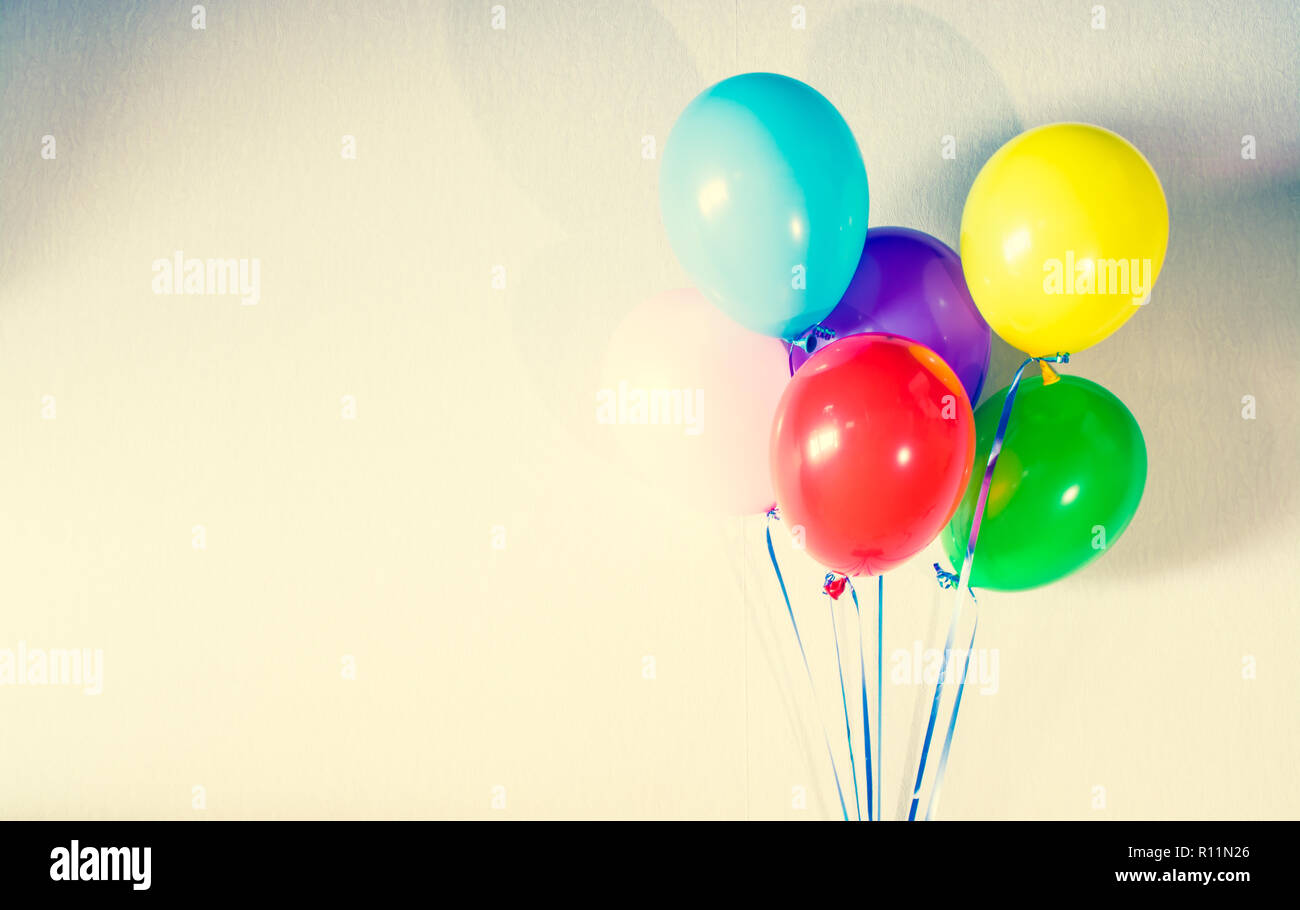 Colorful balloons on grunge wall background. Old retro vintage style ...