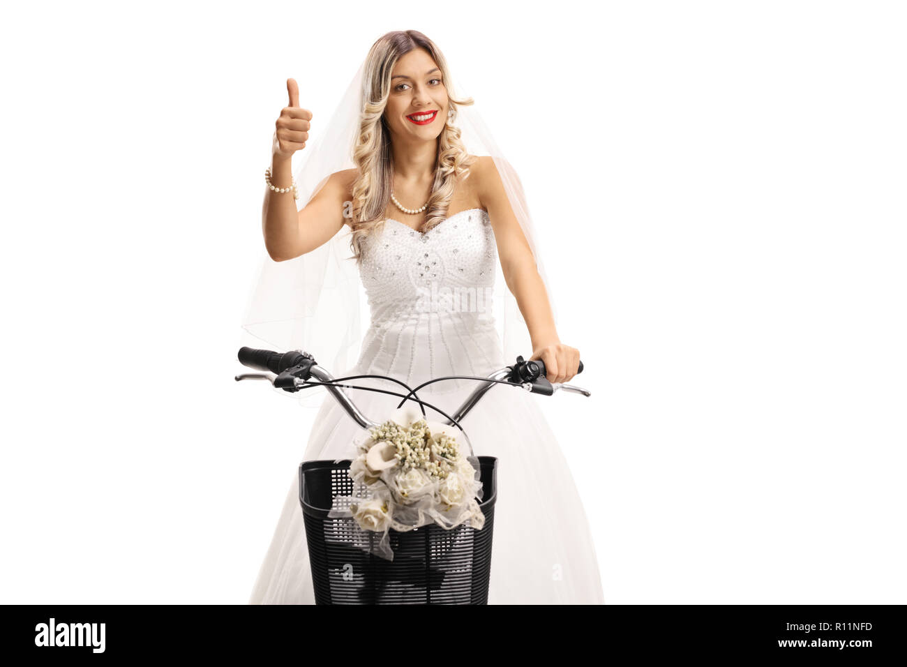 Bride riding a bicycle and giving thumbs up isolated on white ...
