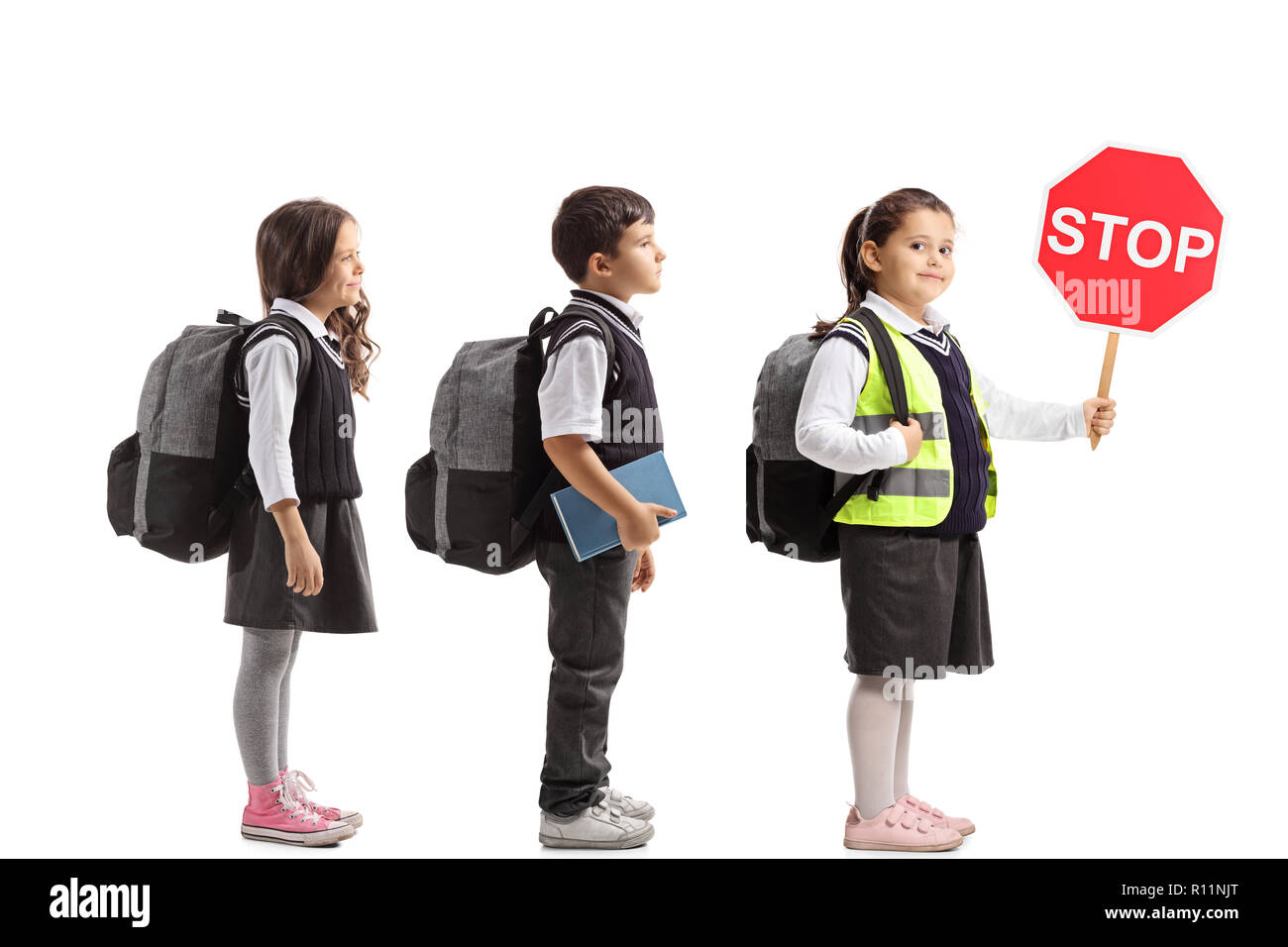 Full length shot of schoolchildren waiting in line with one of them ...