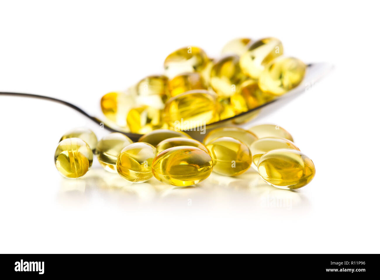 Omega 3 gel capsules in spoon isolated on white background Stock Photo ...