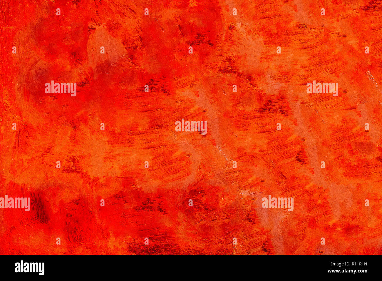 Red metal plate painted with strong red and orange vivid colours as ...