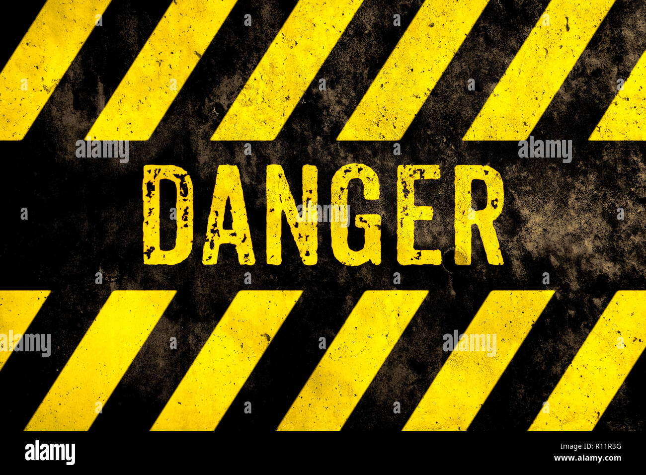 Danger warning sign text with yellow and black stripes painted over ...