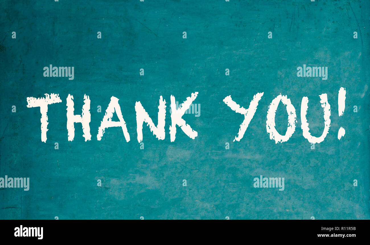 Thank you! text message in white chalk letters written on a school ...