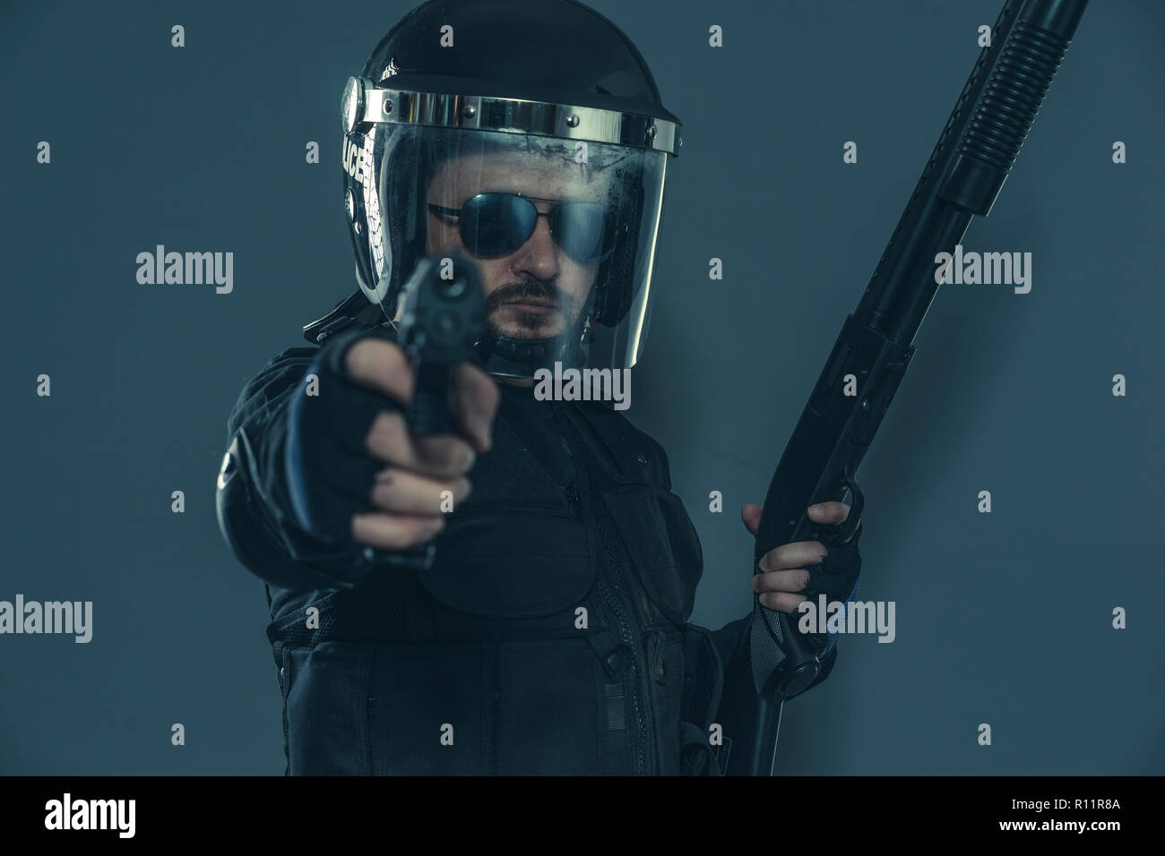 Guard, riot police signaling to colleagues with their hands. armed man ...