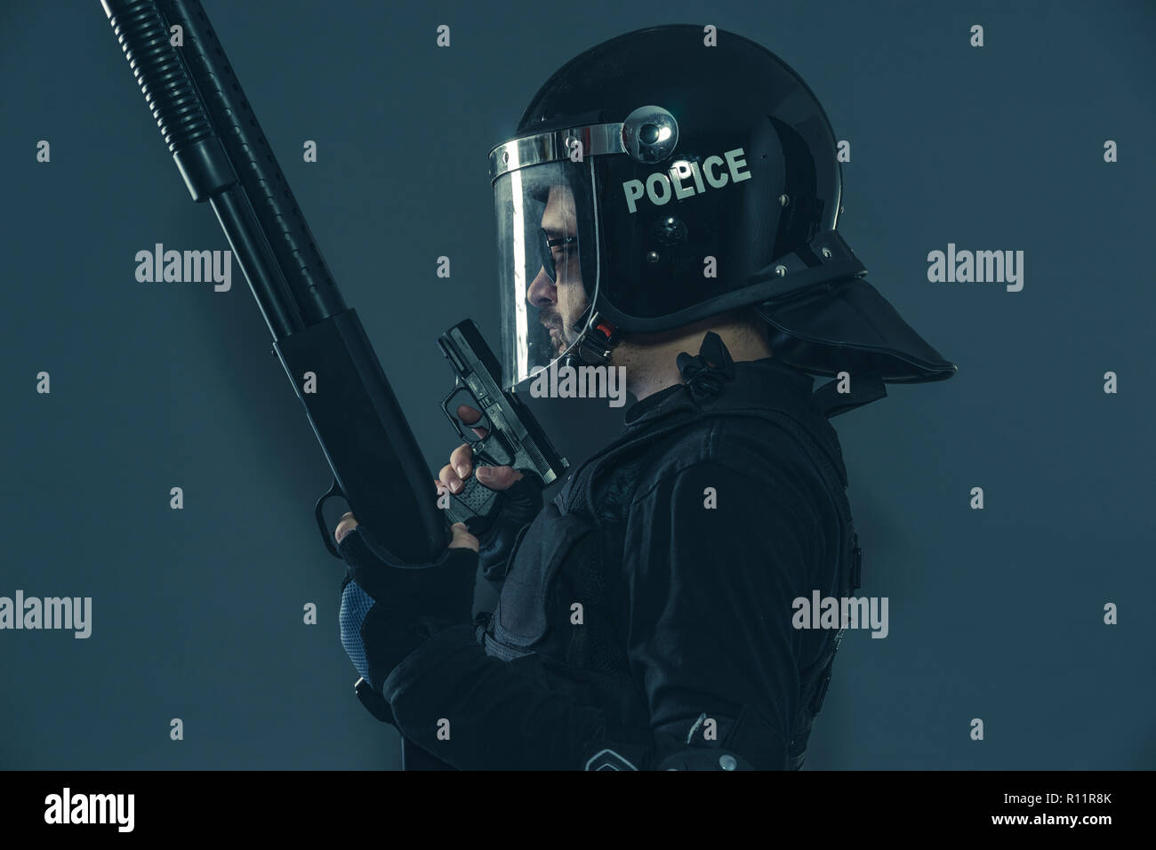 Officer, riot police signaling to colleagues with their hands. armed ...