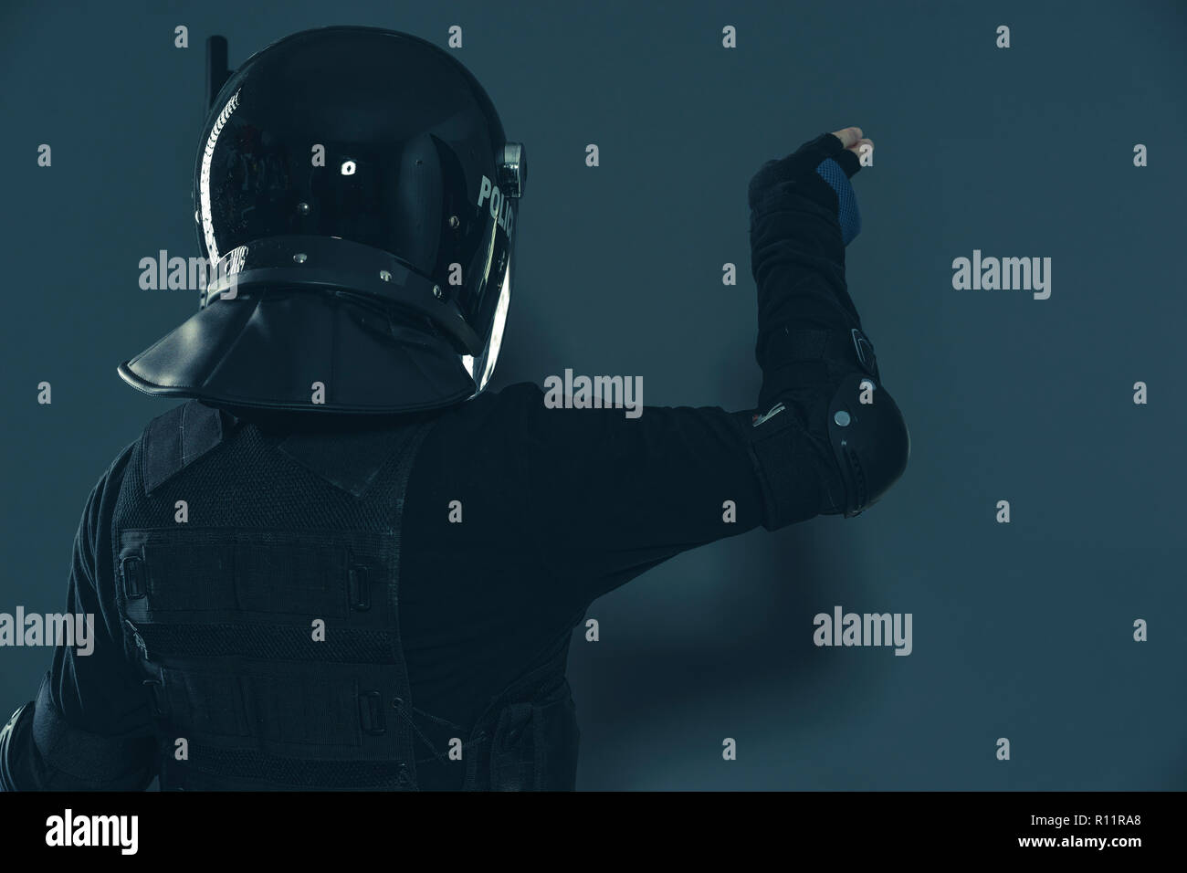 riot police signaling to colleagues with their hands. armed man with ...