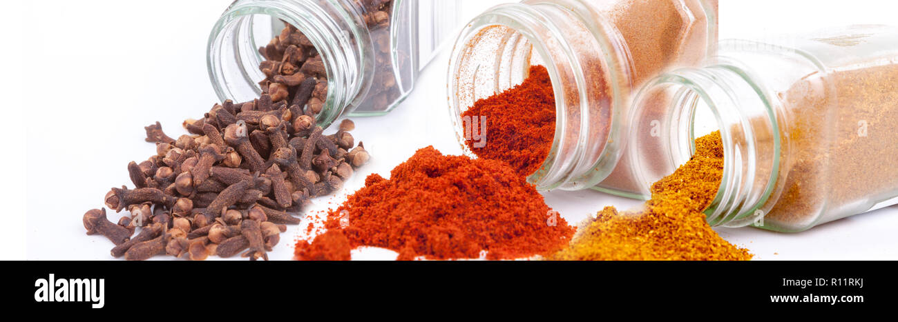 A still life with dried spices spilling from glass jars Stock Photo - Alamy