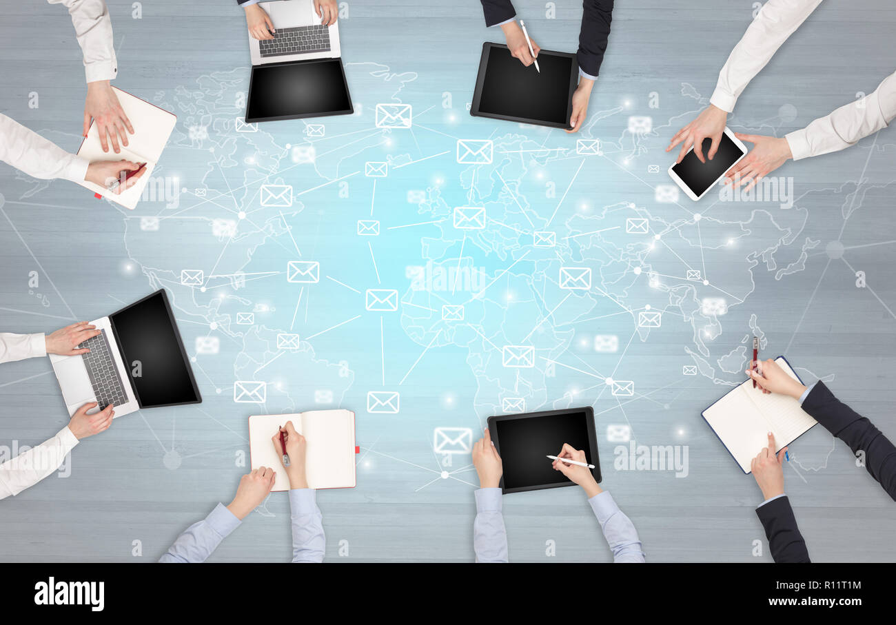 Group of people with devices in hands working in team on tablets ...