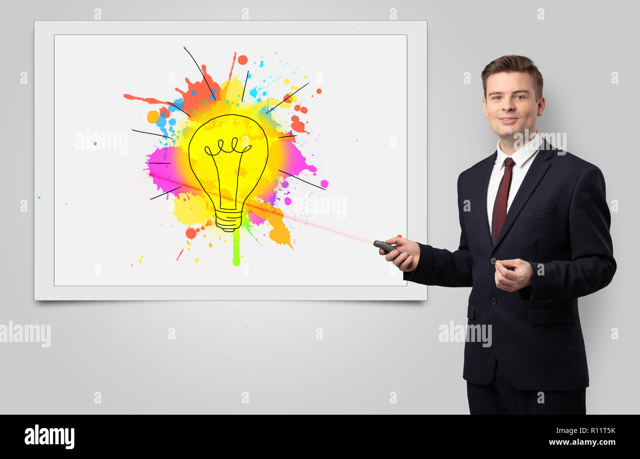 Man with laser pointer presenting innovative idea Stock Photo - Alamy