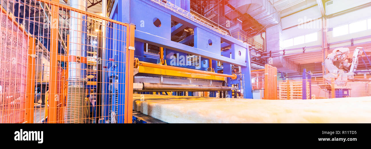 Fiberglass production industry equipment at manufacture background ...