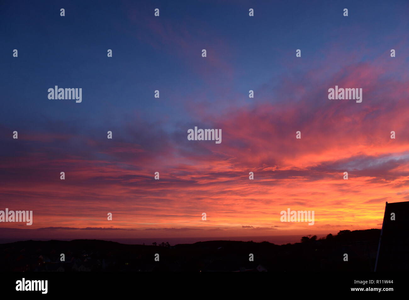 Sunset at Mumbles. A Setting Sun disappears below the horizon causing ...
