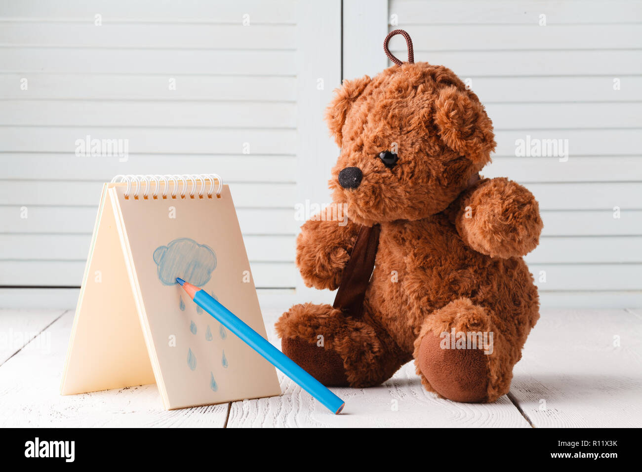 Teddy bear draw rainy weather sign Stock Photo - Alamy