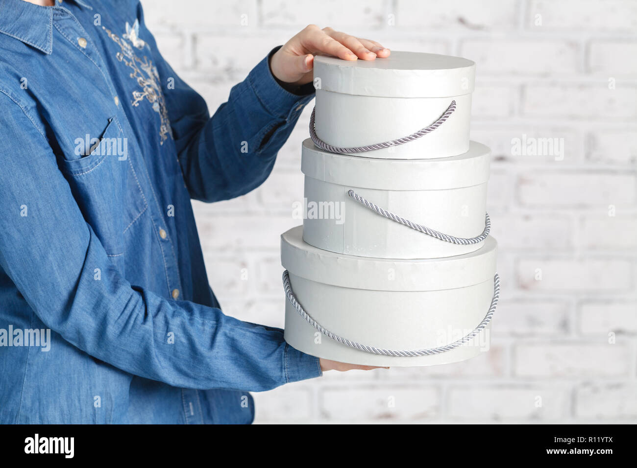 few gift box in female hands Stock Photo - Alamy