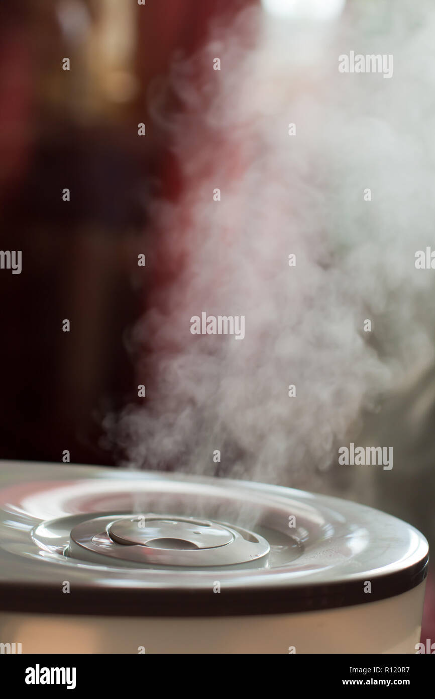 Humidifier spreading steam into the living room Stock Photo - Alamy