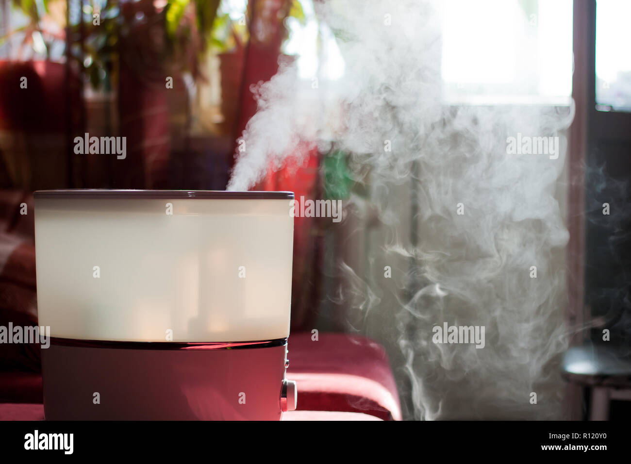Humidifier spreading steam into the living room Stock Photo - Alamy