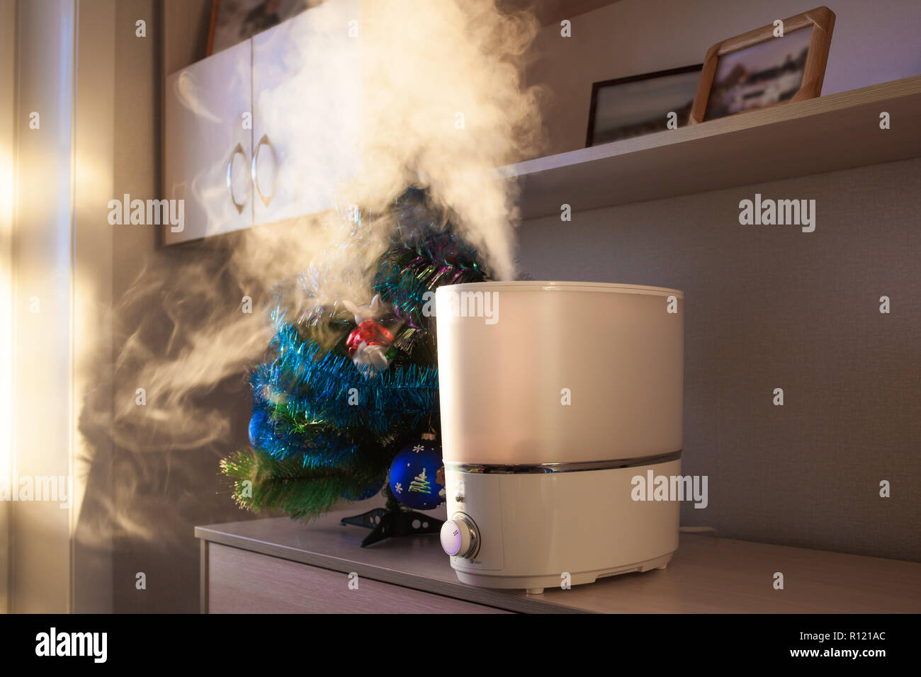 Humidifier spreading steam into the living room Stock Photo - Alamy