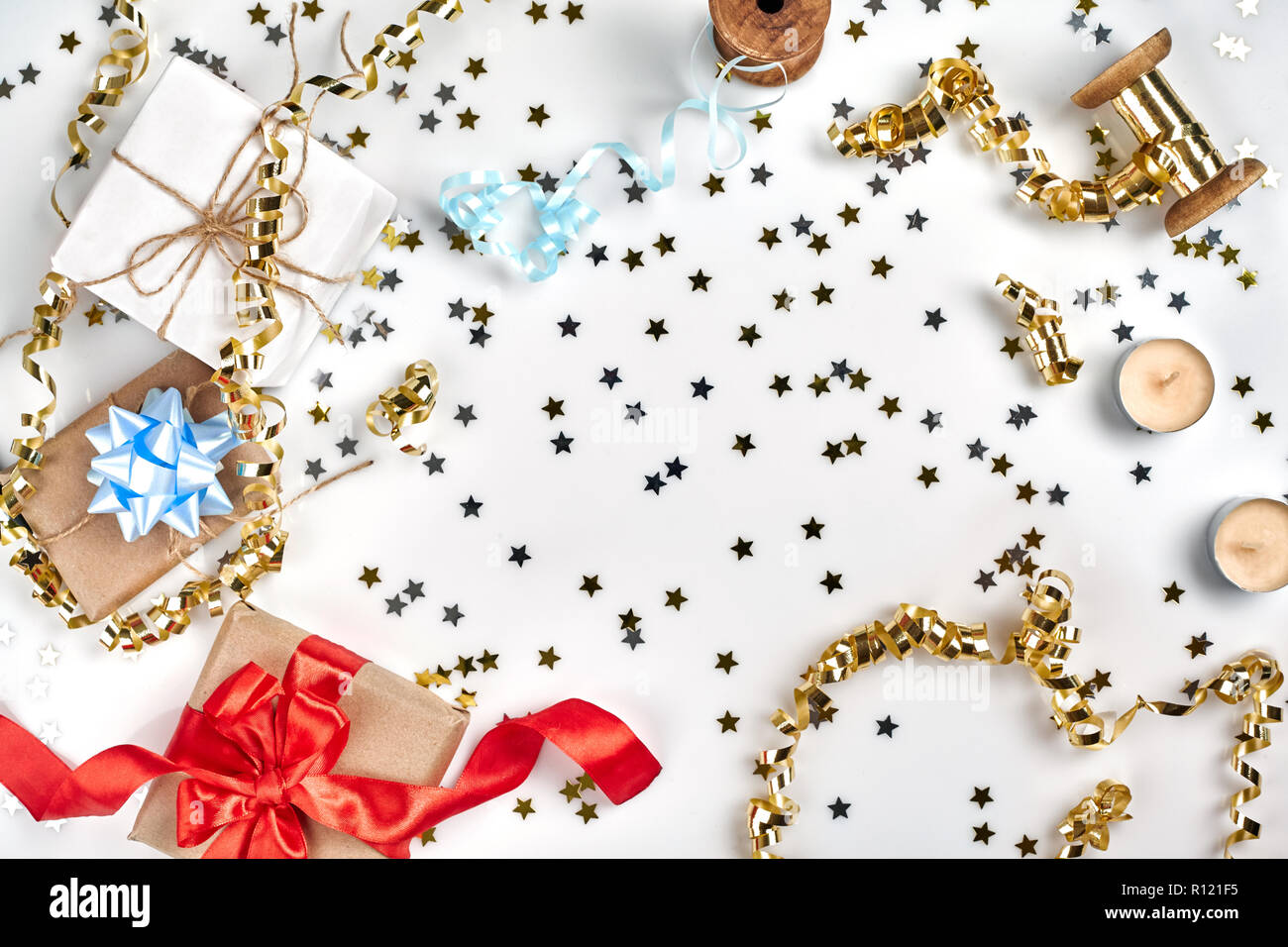 Delicate wavy ribbons and metallic star shaped confetti isolated on ...