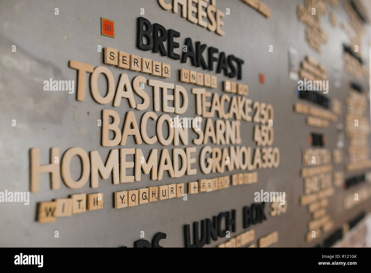 Low angle view of breakfast menu on the wall in a cafe. They have used ...