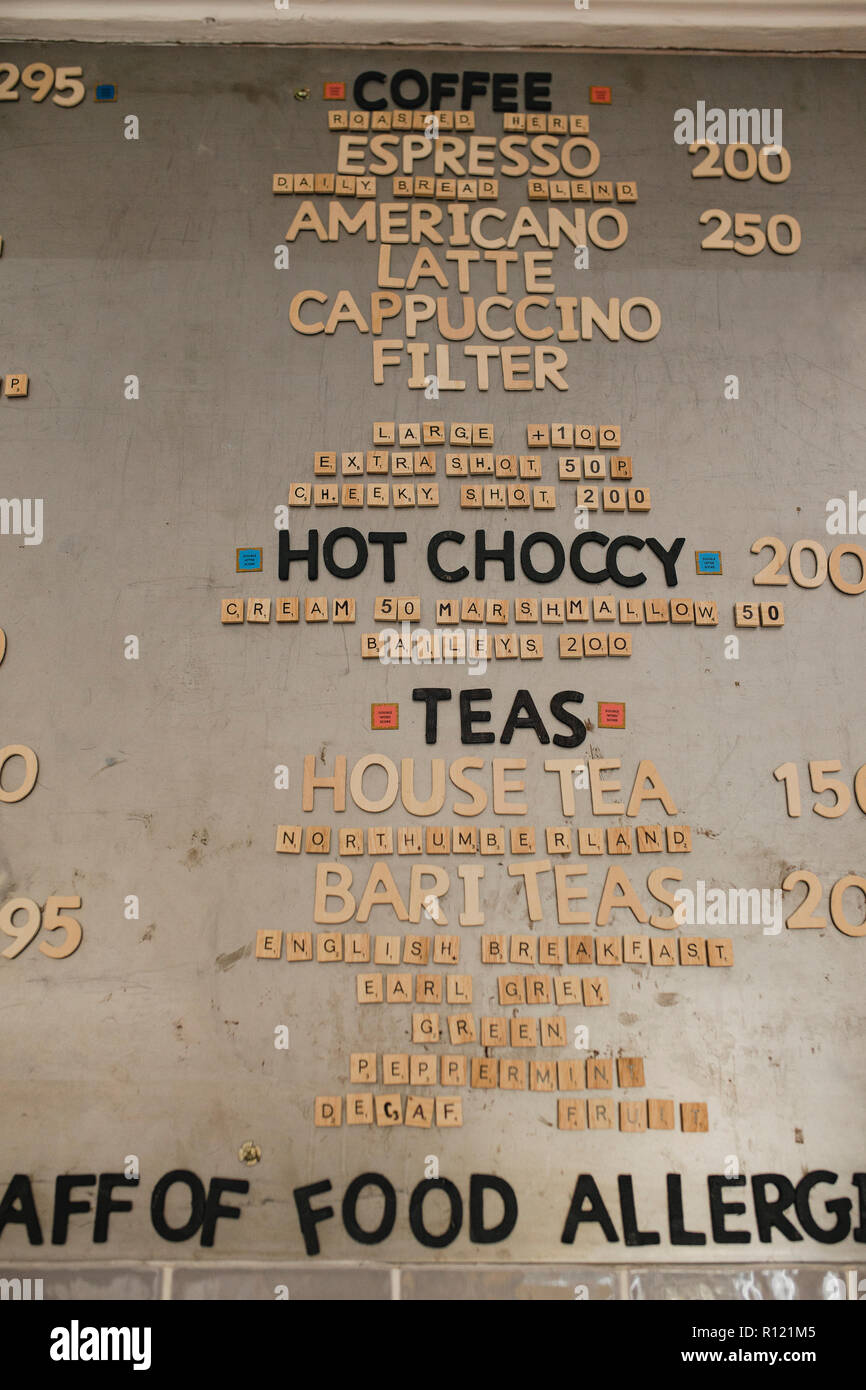 Low angle view of a hot drinks menu on the wall in a cafe. They have ...