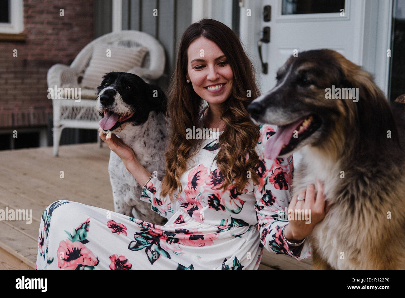 Woman and her two dogs sitting on porch Stock Photo - Alamy