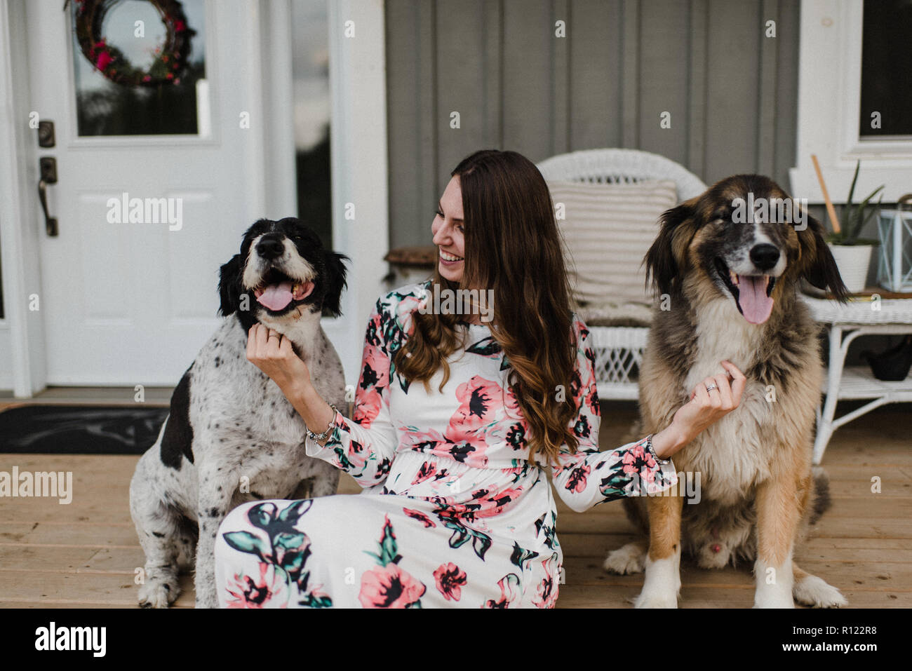 Woman and her two dogs sitting on porch Stock Photo - Alamy