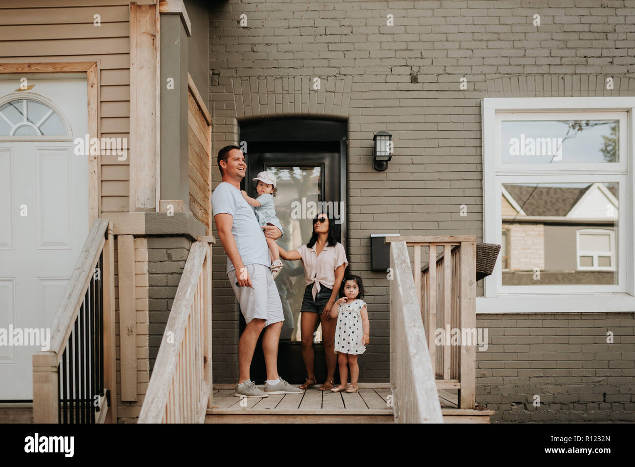Family In Front Of Home