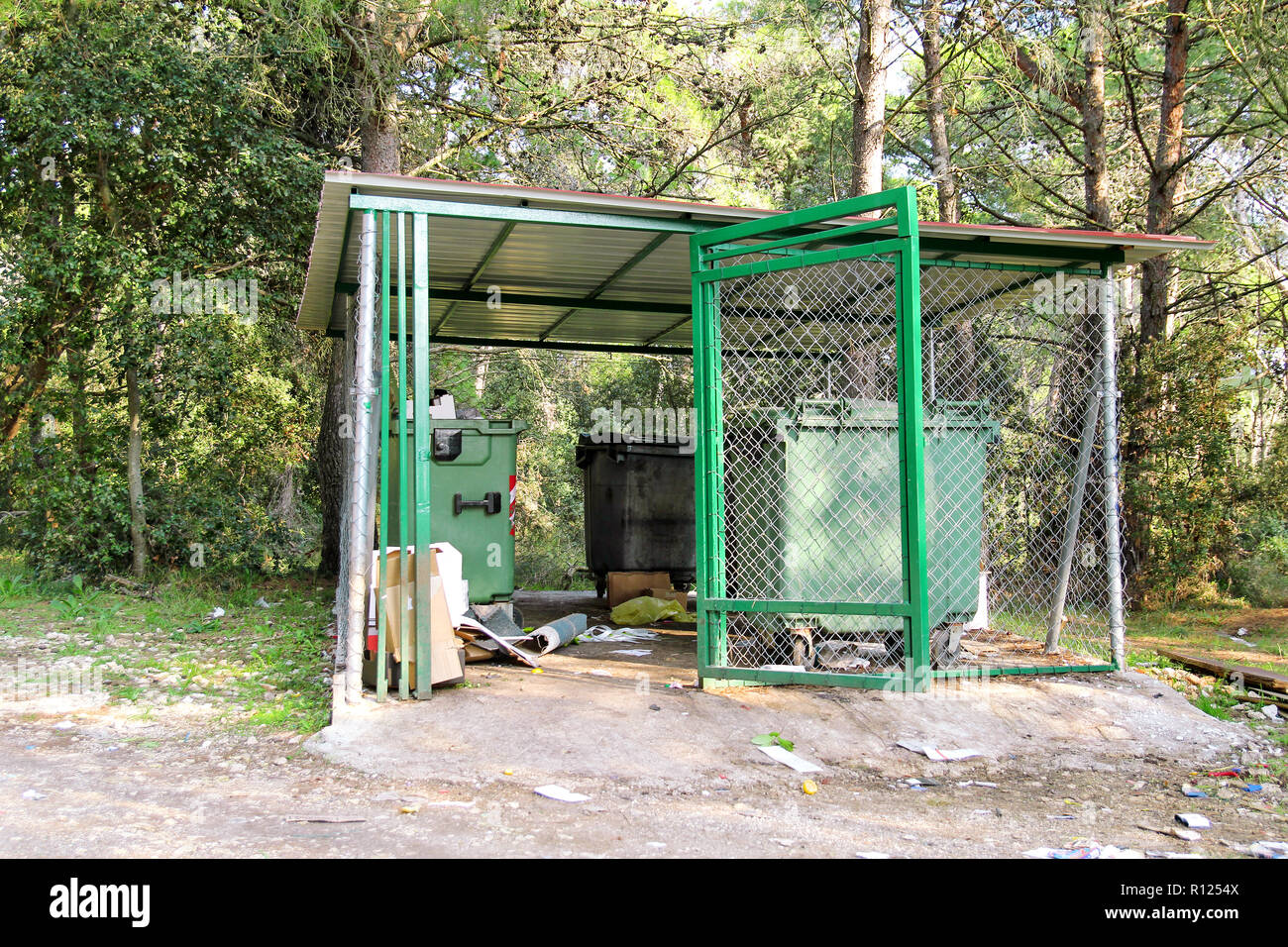 Garbage containers in fence cage / Orderly stowed garbage cans for ...