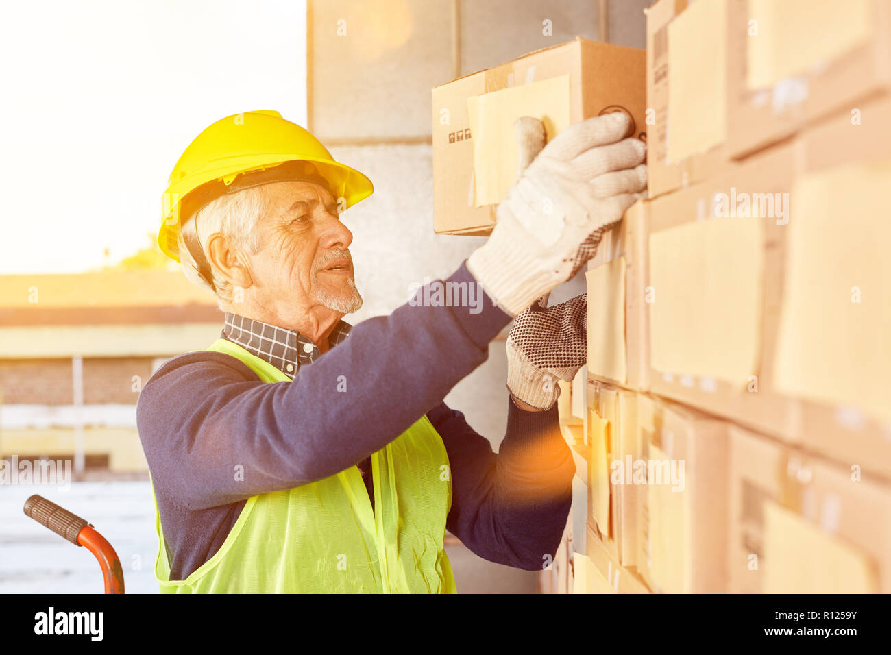 Senior warehouse worker in warehouse at parcel delivery for shipping ...