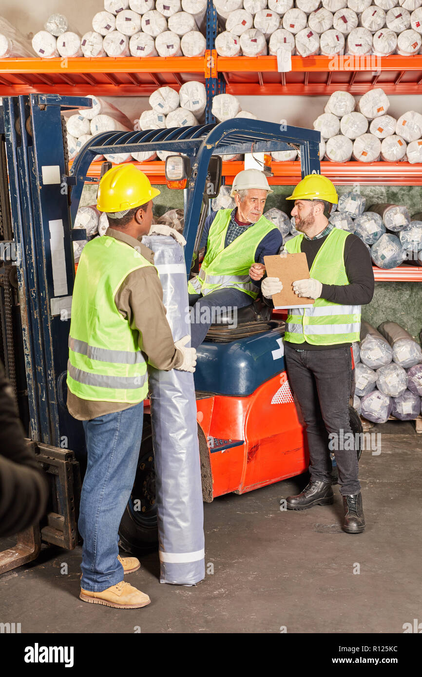 Logistics workers and forklift drivers work together in the shipping ...