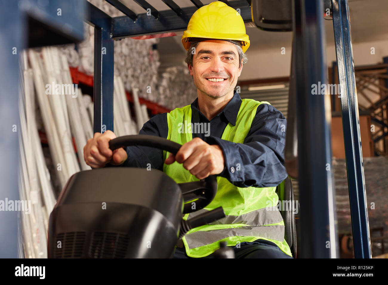 Forklift driver on the forklift transports cargo at the logistics ...