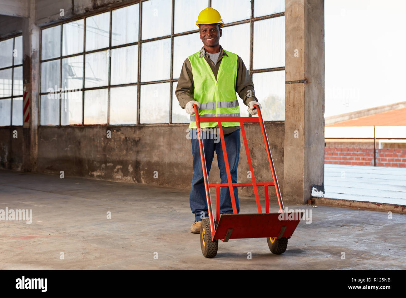 African man as a warehouse worker of a freight forwarder with a ...