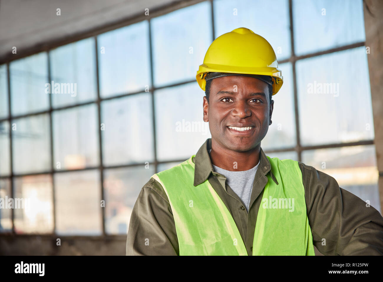 African worker or warehouse worker with hard hat in a warehouse Stock ...