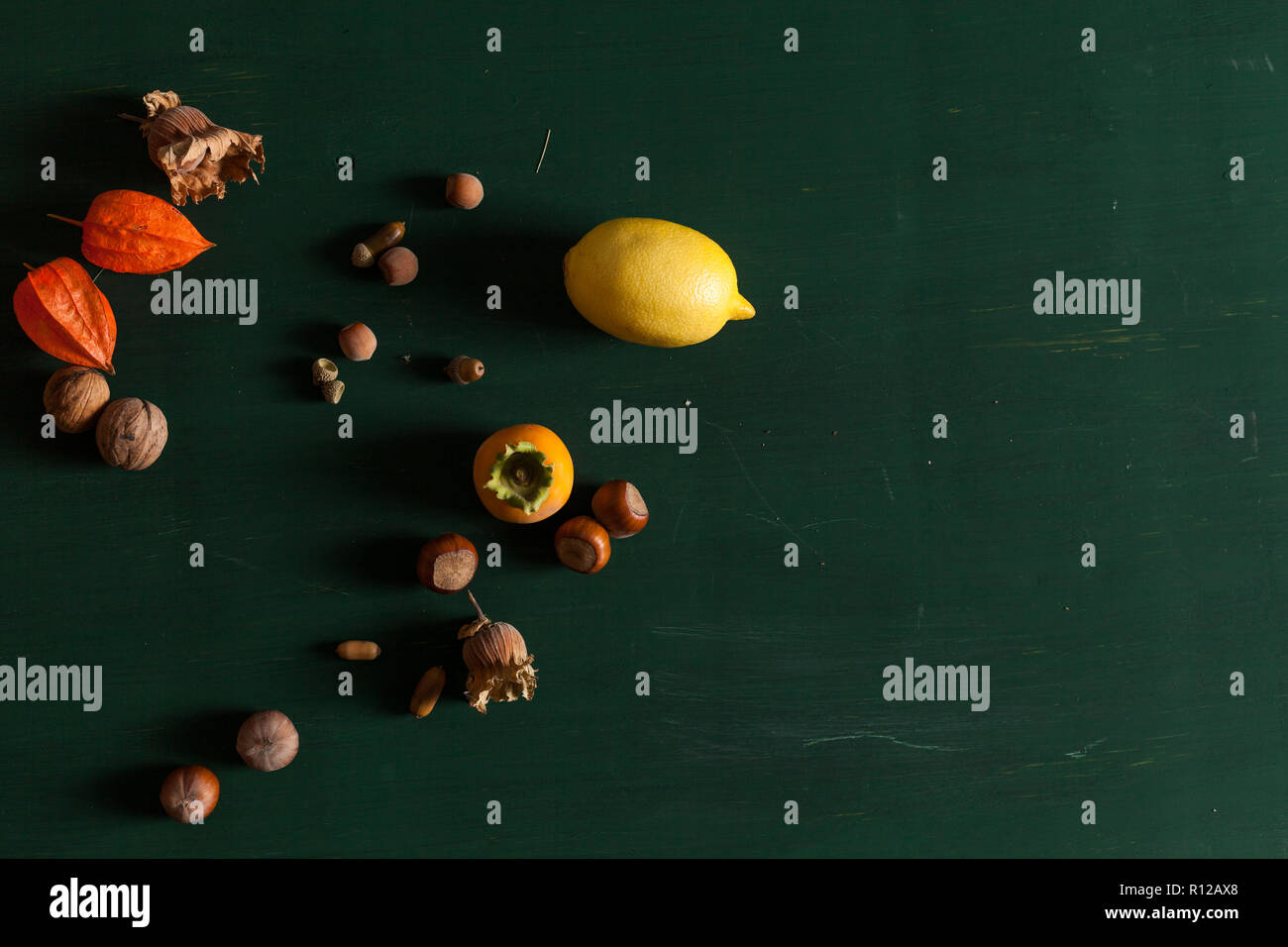autumn nuts citrus on a green background Stock Photo - Alamy