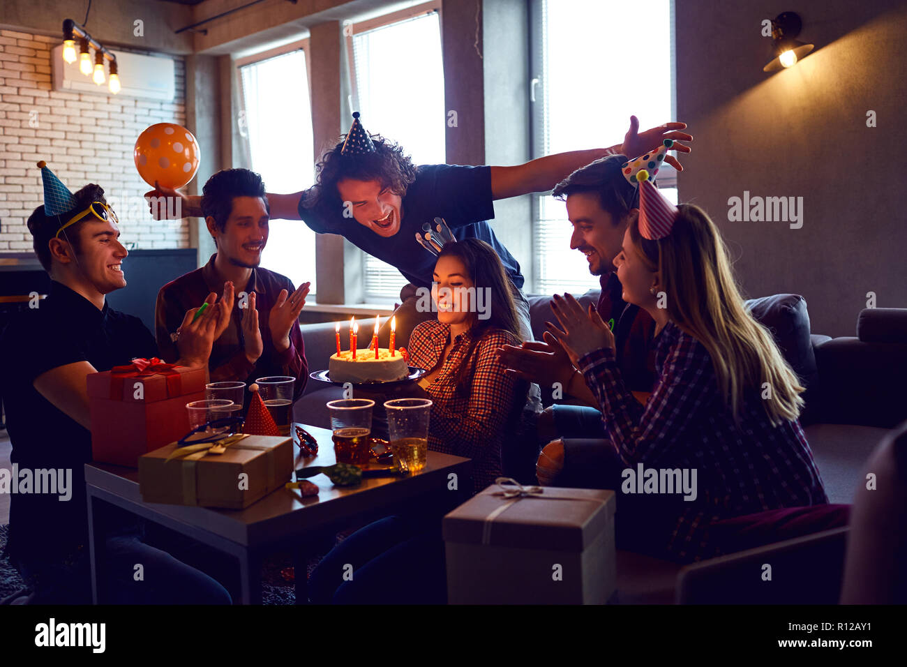 Friends with birthday cake celebrating birthday at a party Stock Photo ...