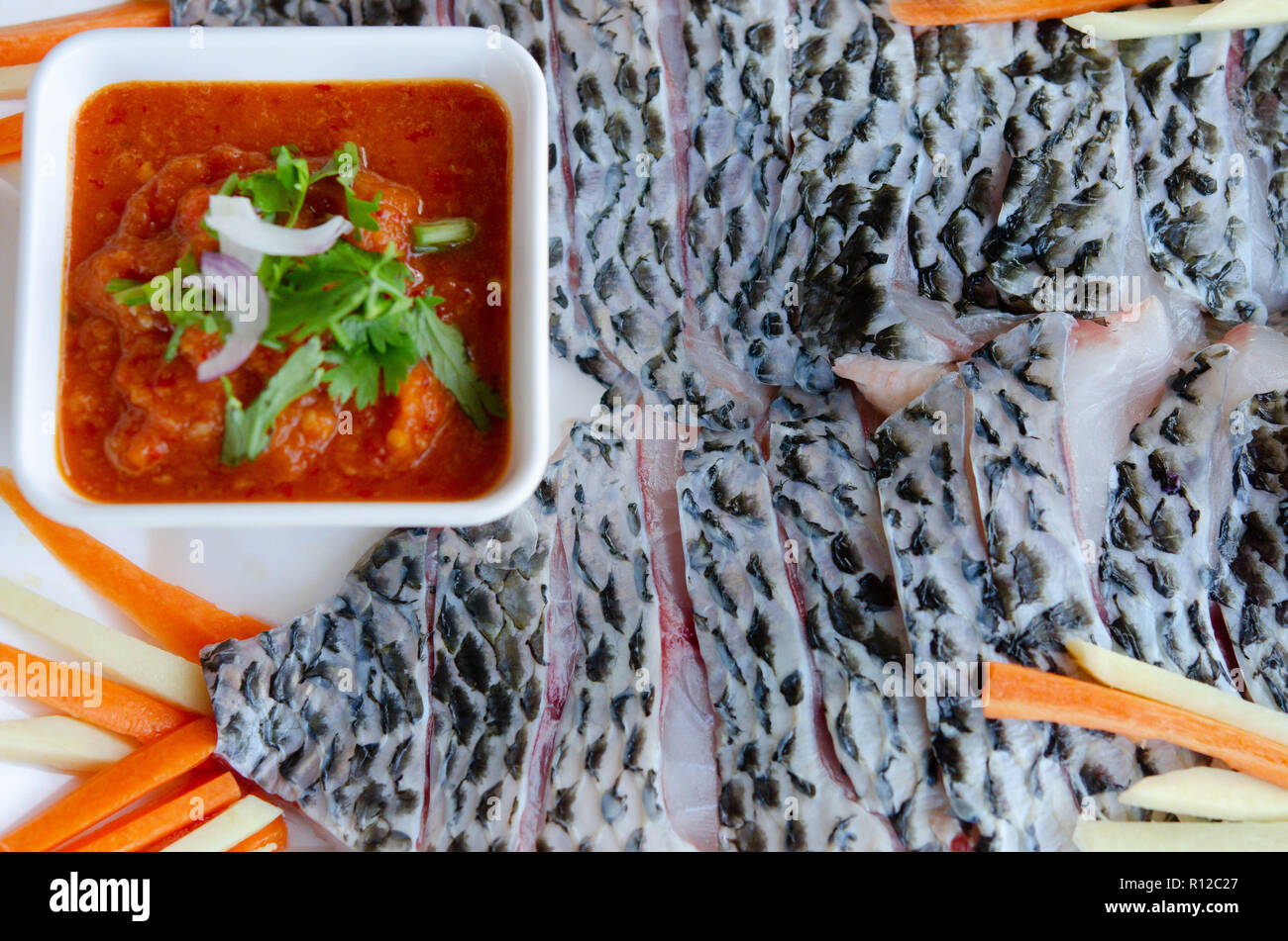 filet of raw fish served with spicy chili sauce Stock Photo - Alamy