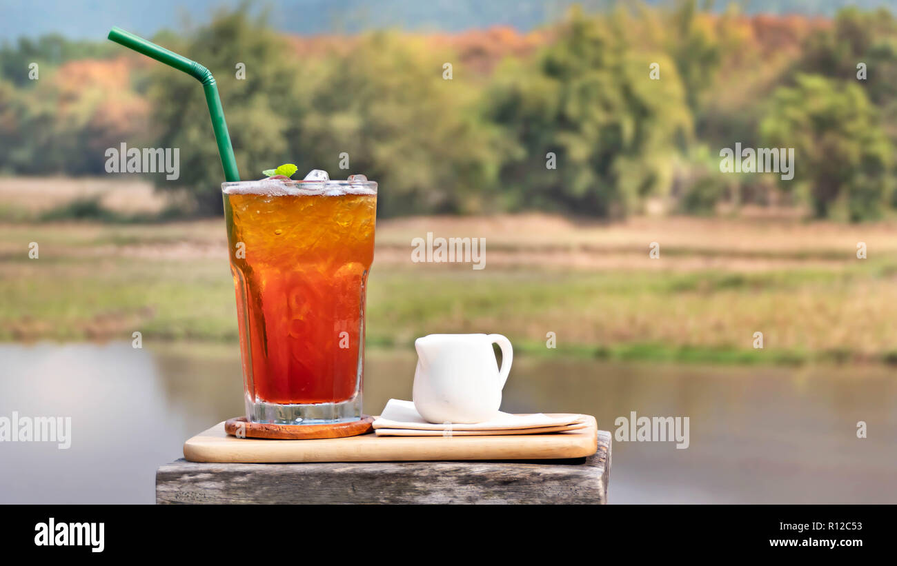 Glass of iced tea on nature background Stock Photo - Alamy