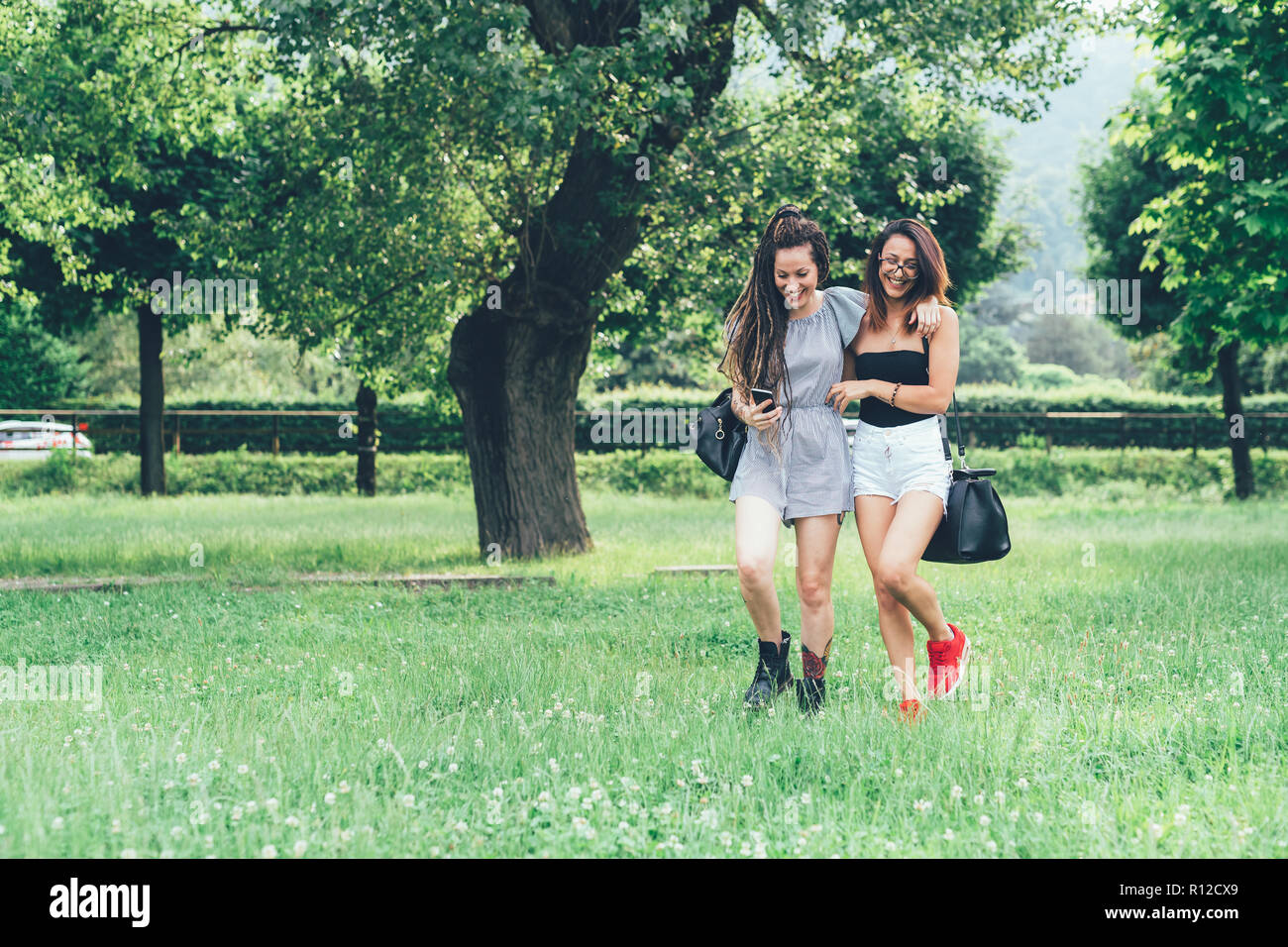Two girlfriends walking park hi-res stock photography and images - Alamy