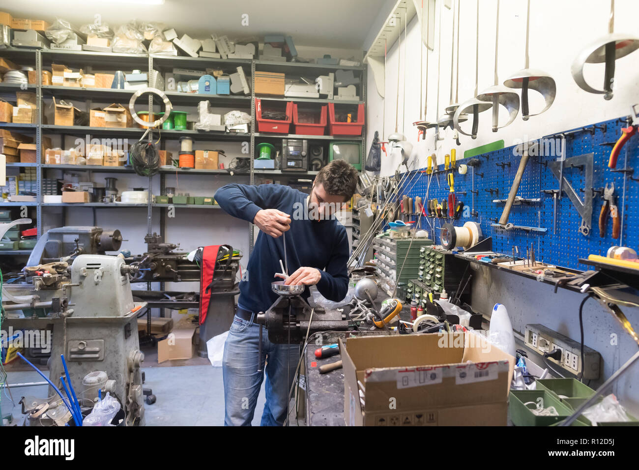 Fencing prop maker at work Stock Photo - Alamy
