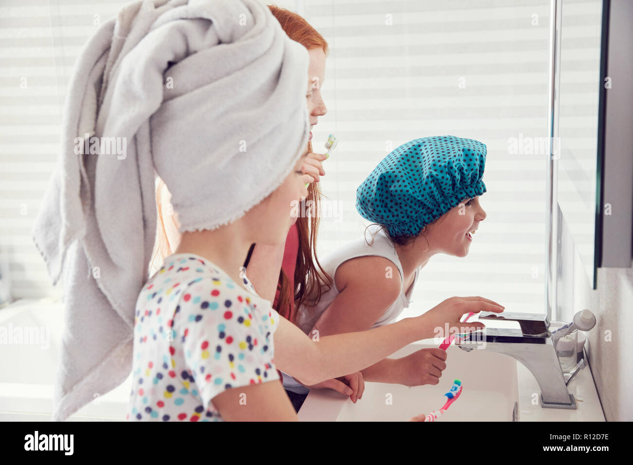 Girls brushing teeth Stock Photo - Alamy