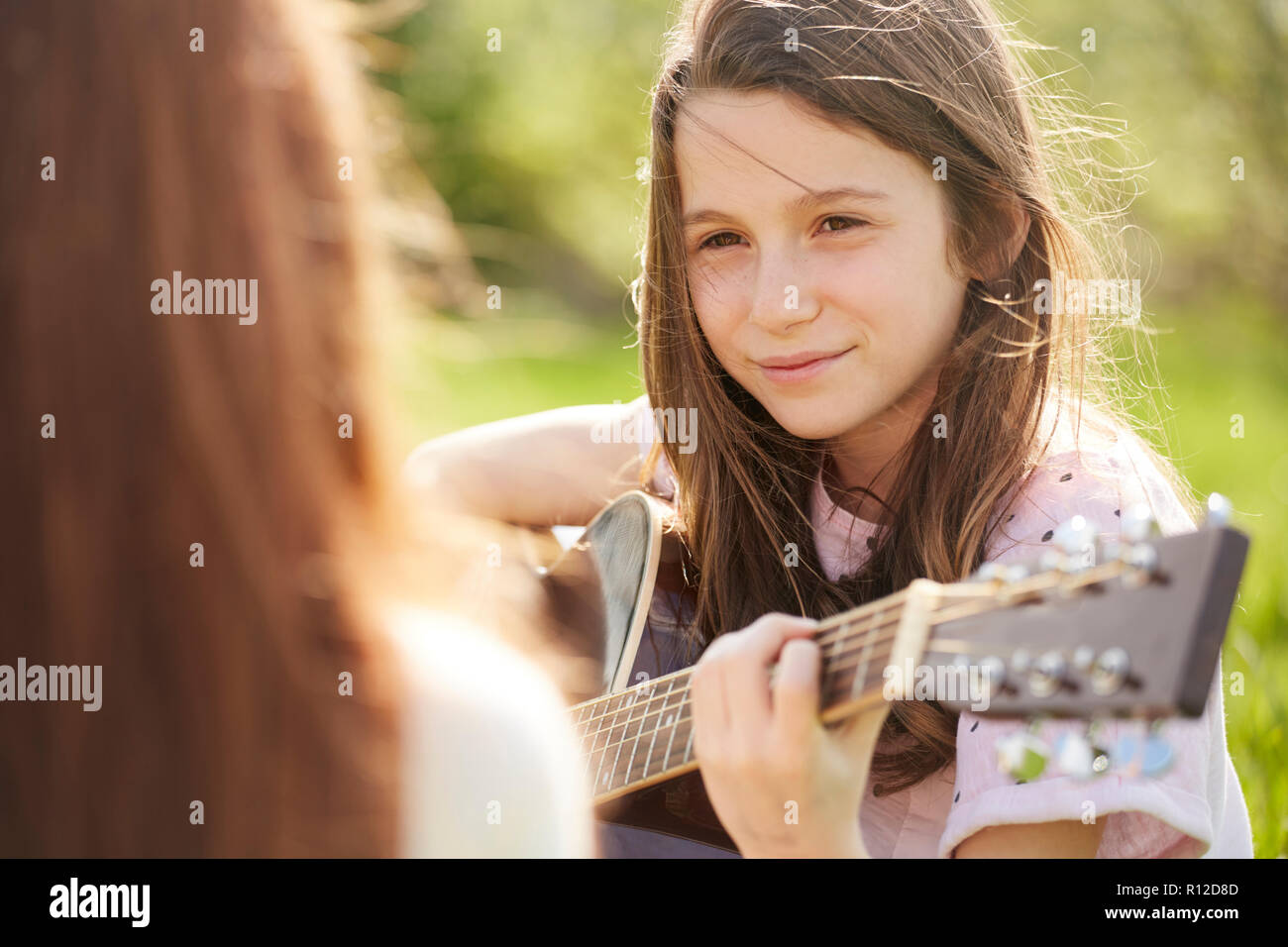 Girl playing guitar Stock Photo - Alamy