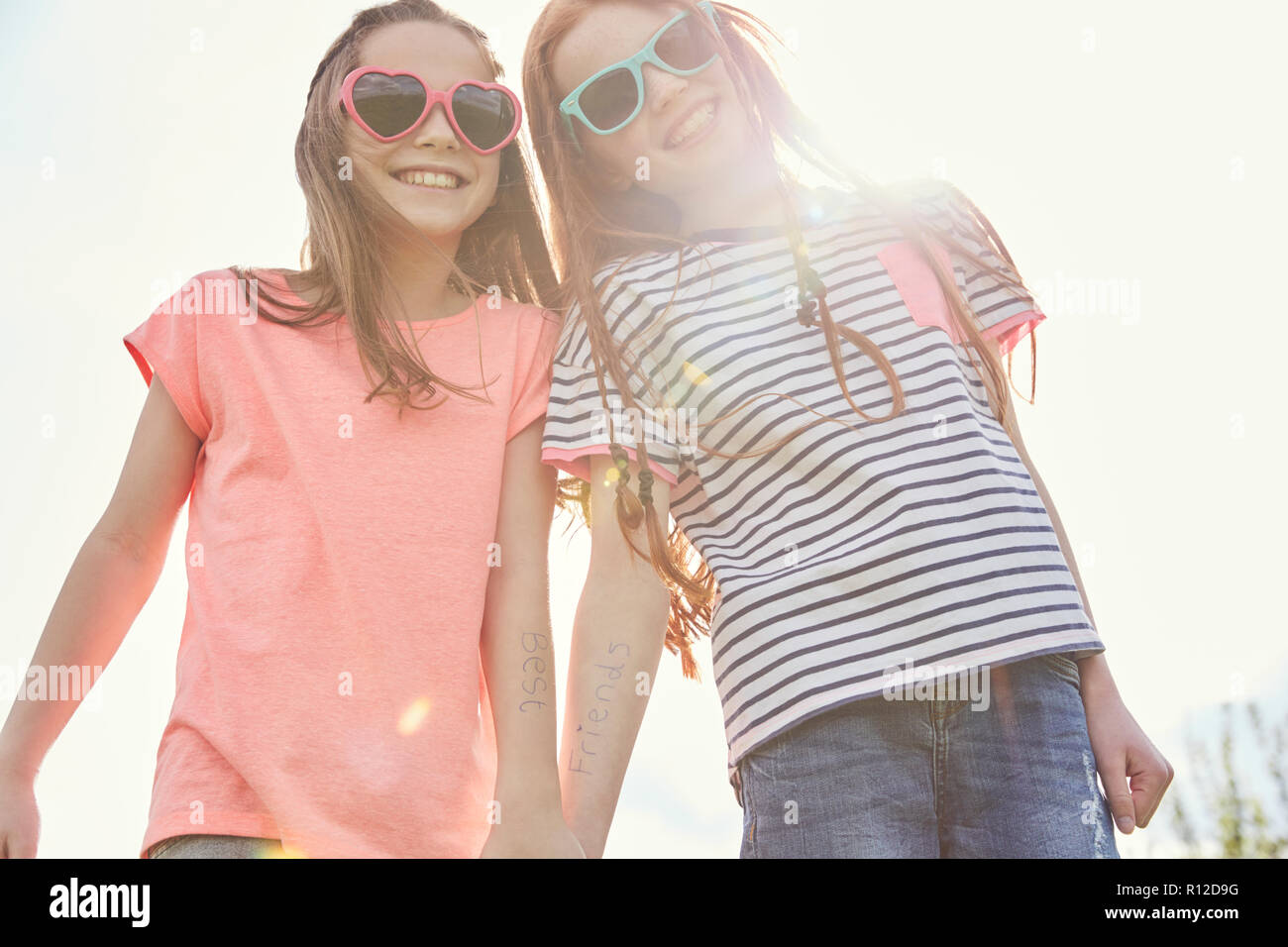 Best friends walking hand in hand Stock Photo - Alamy